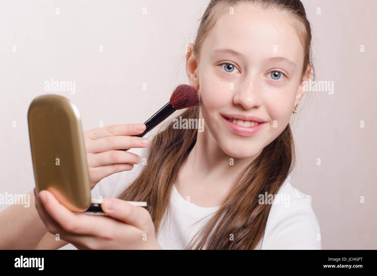 Teen girl having a fun painted cosmetics Stock Photo - Alamy