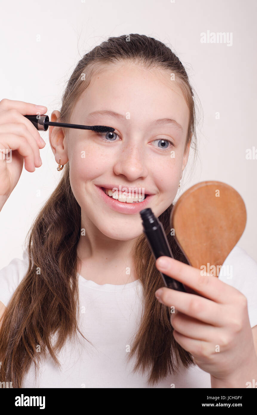 Teen girl having a fun painted cosmetics Stock Photo - Alamy