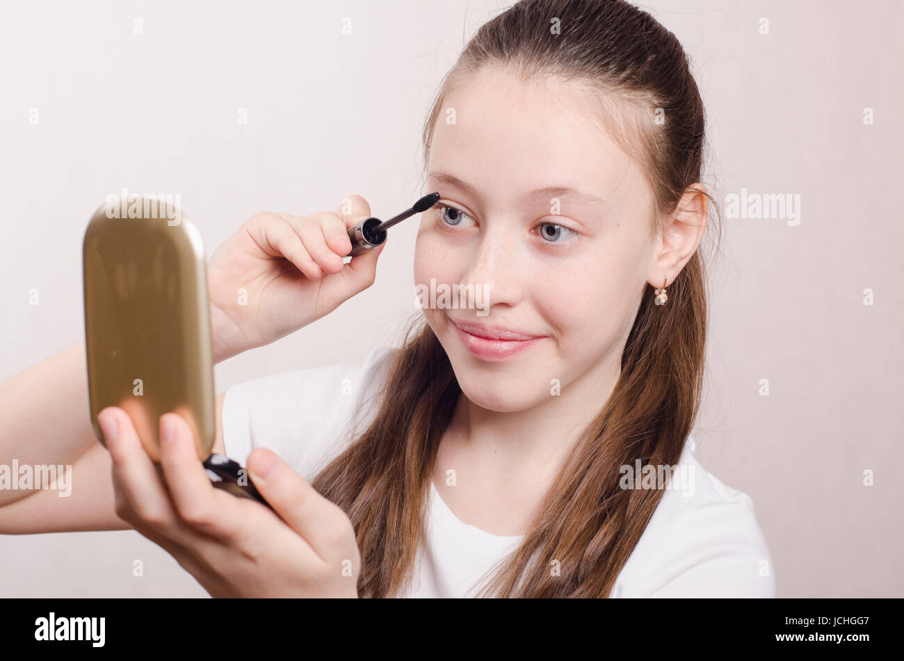 Teen girl having a fun painted cosmetics Stock Photo - Alamy