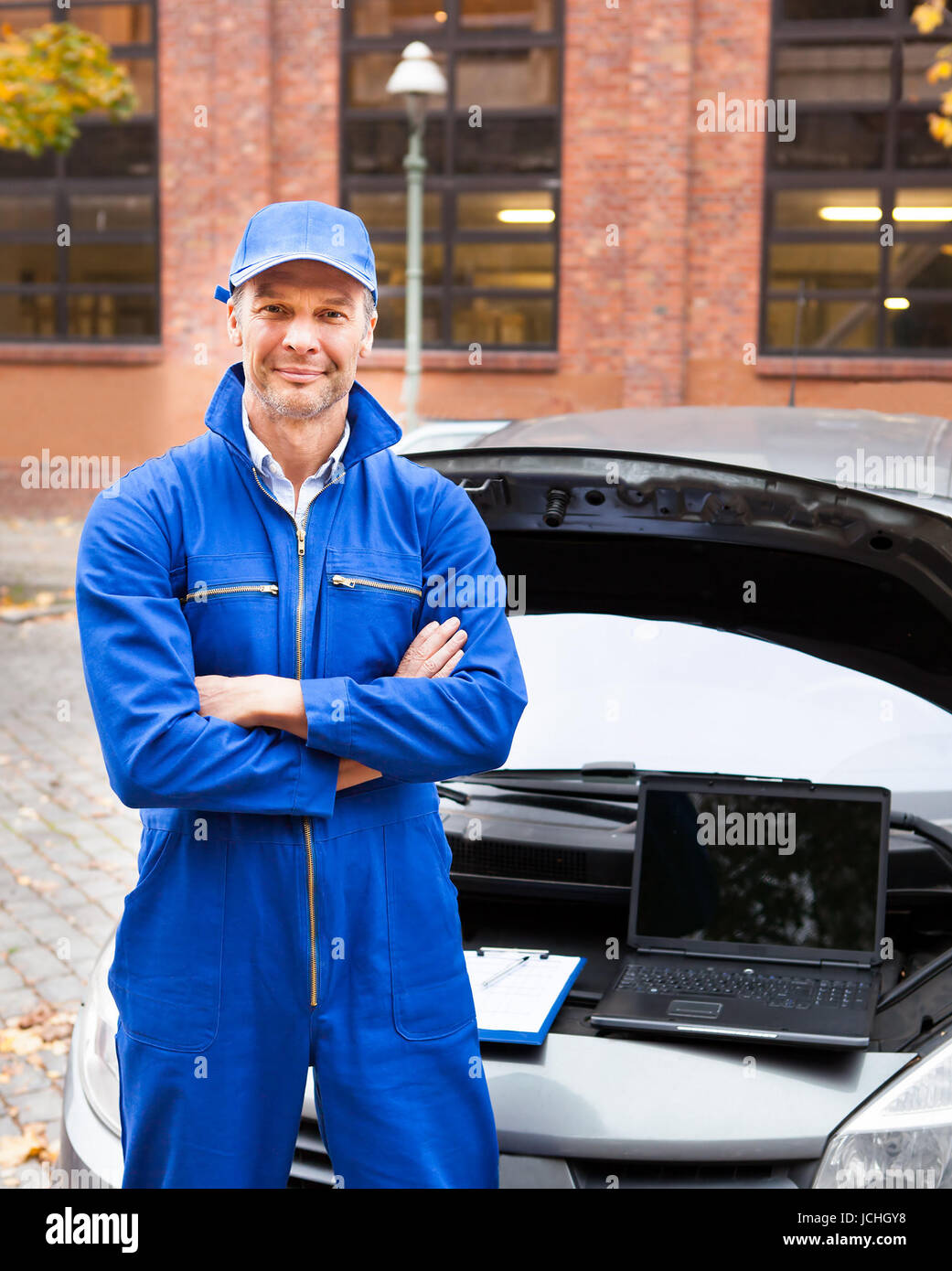 Portrait Of A Male Car Mechanic With Arm Crossed Stock Photo - Alamy