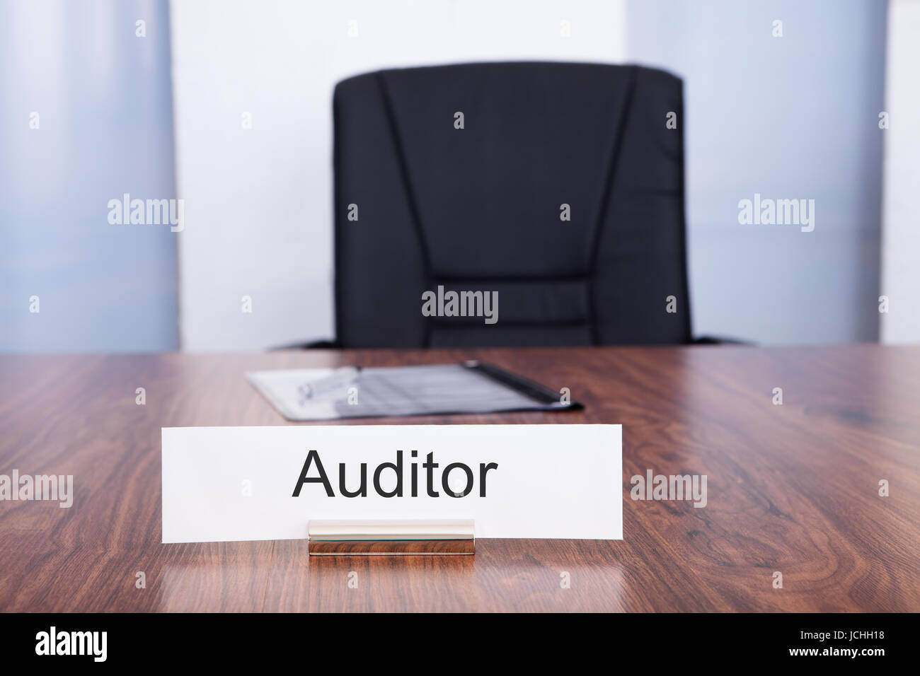 Nameplate With Auditor Title Kept On Desk In Front Of Empty Chair Stock ...