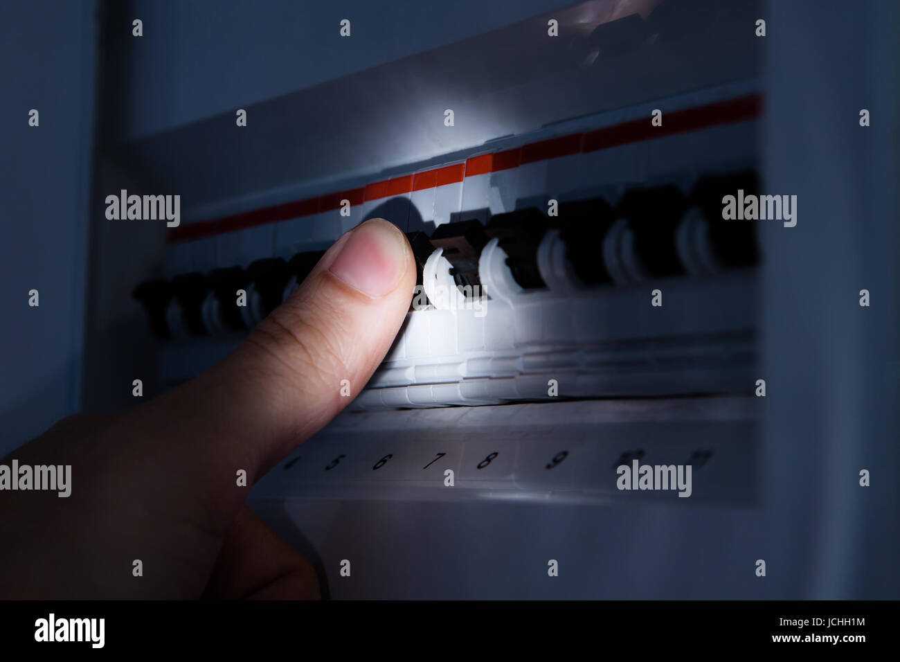 Close-up Of Hand With Light On Electrical Board Stock Photo - Alamy