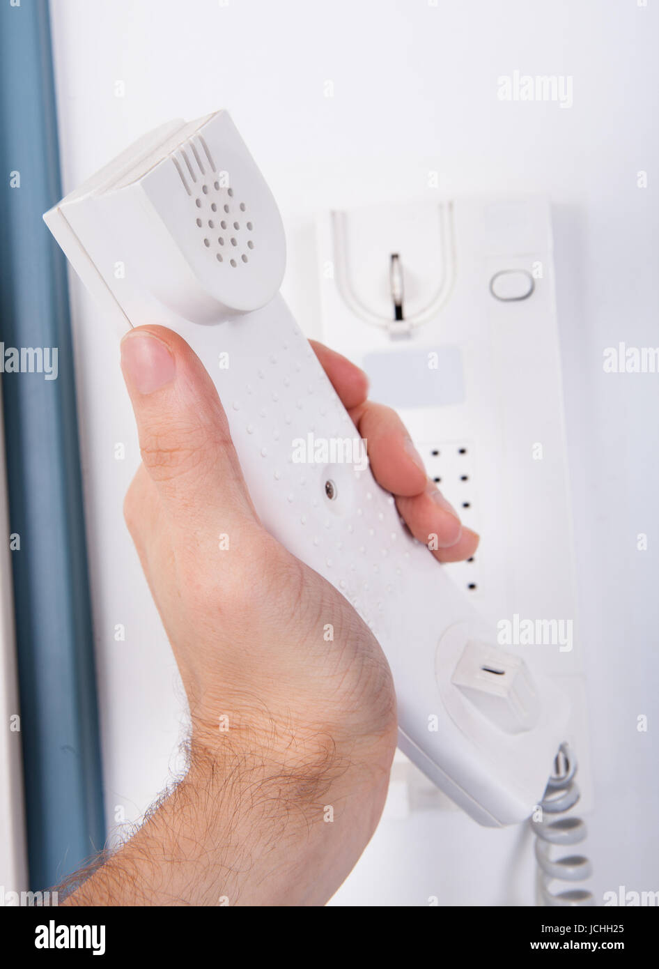 Hand Holding Receiver Attached On White Wall Stock Photo - Alamy