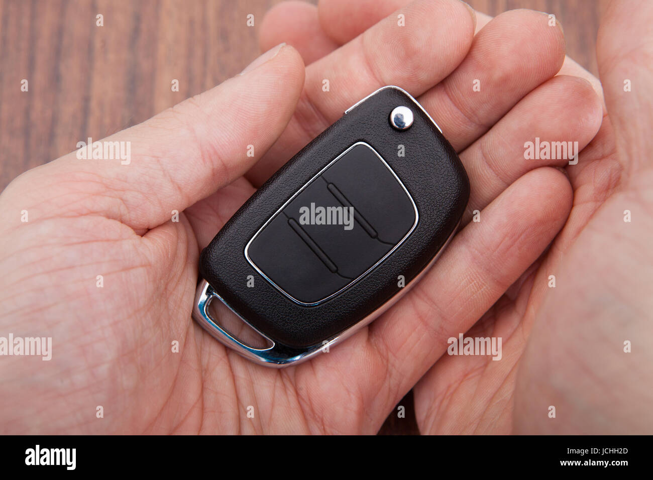 Close-up Of Hand Holding Black Car Key Stock Photo - Alamy