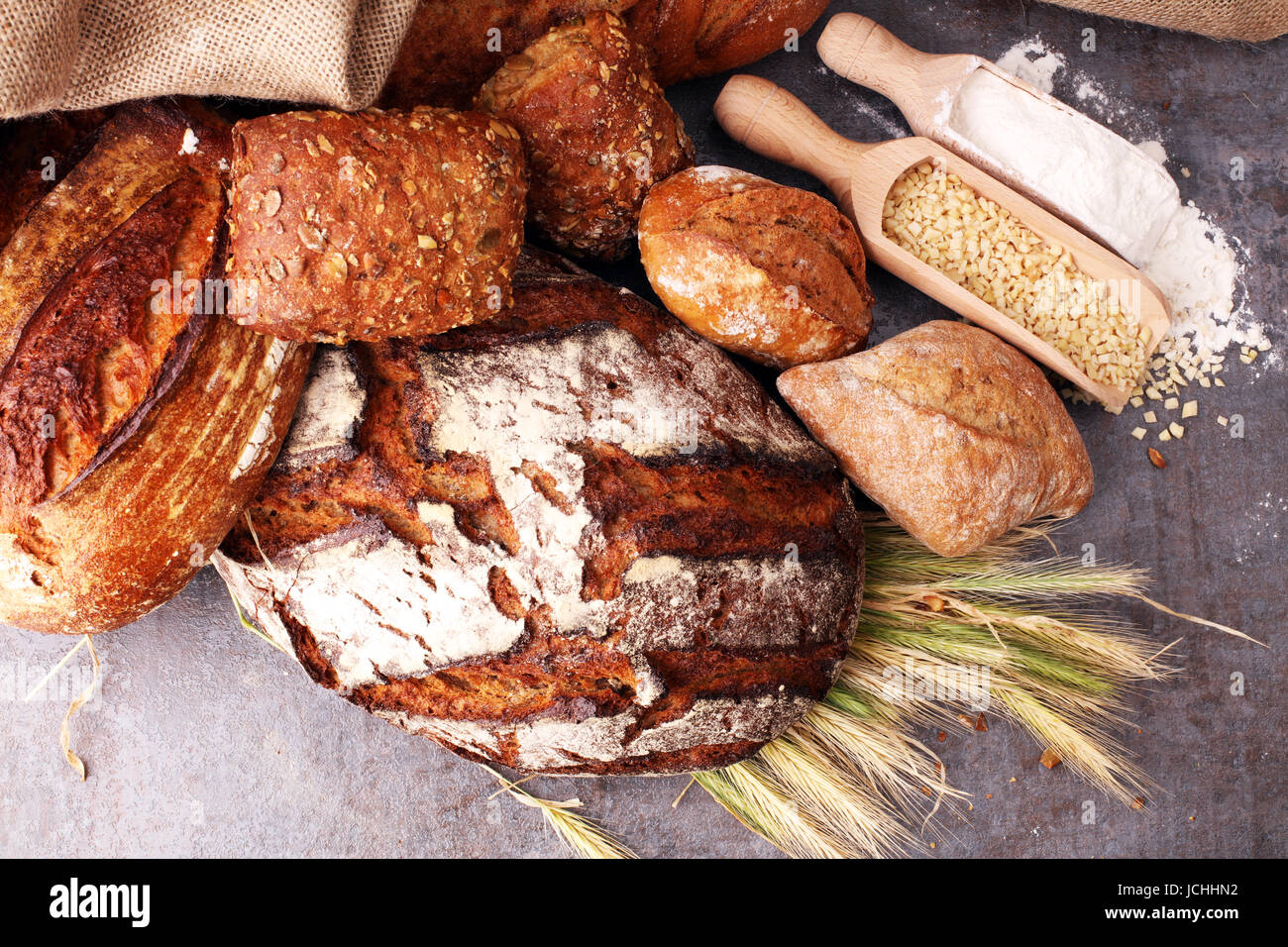 Different kinds of bread and bread rolls on board from above Stock ...