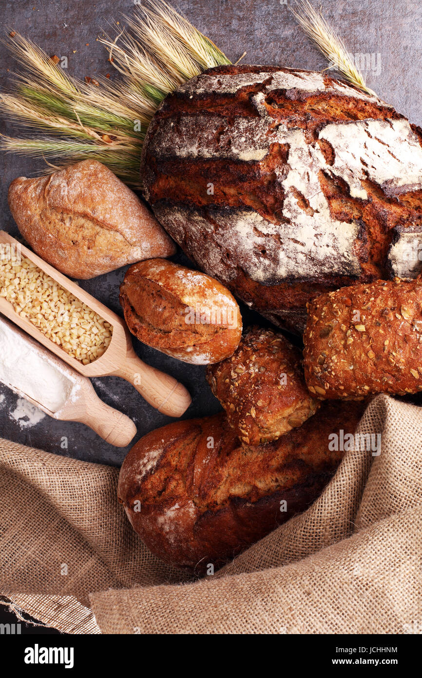 Different kinds of bread and bread rolls on board from above Stock ...
