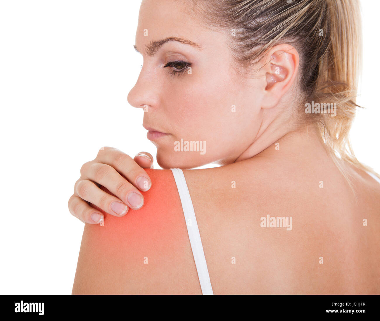 Close up of woman having shoulder pain isolated on white background ...