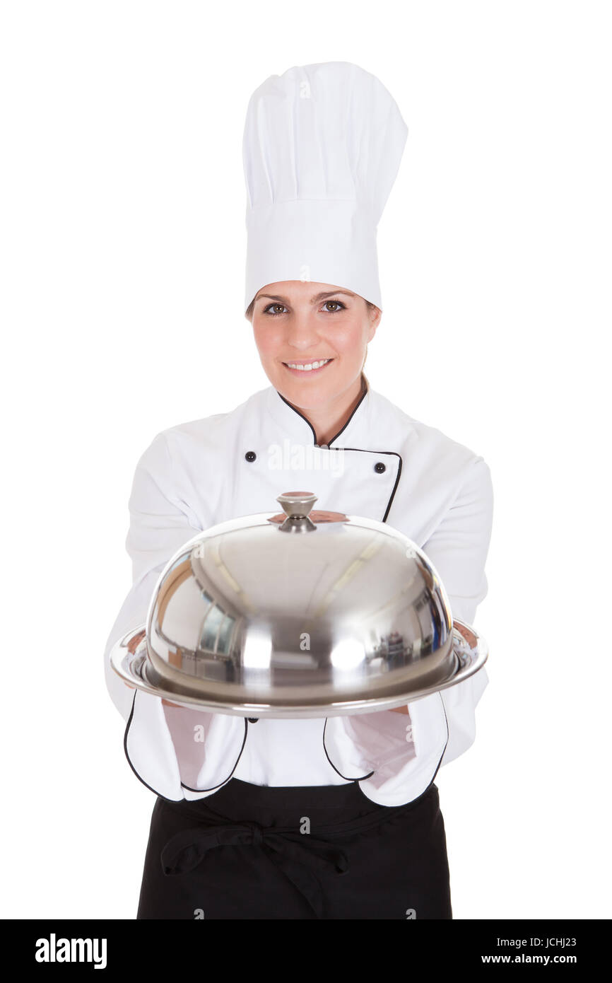 Portrait Of Female Chef Holding Tray Over White Background Stock Photo ...