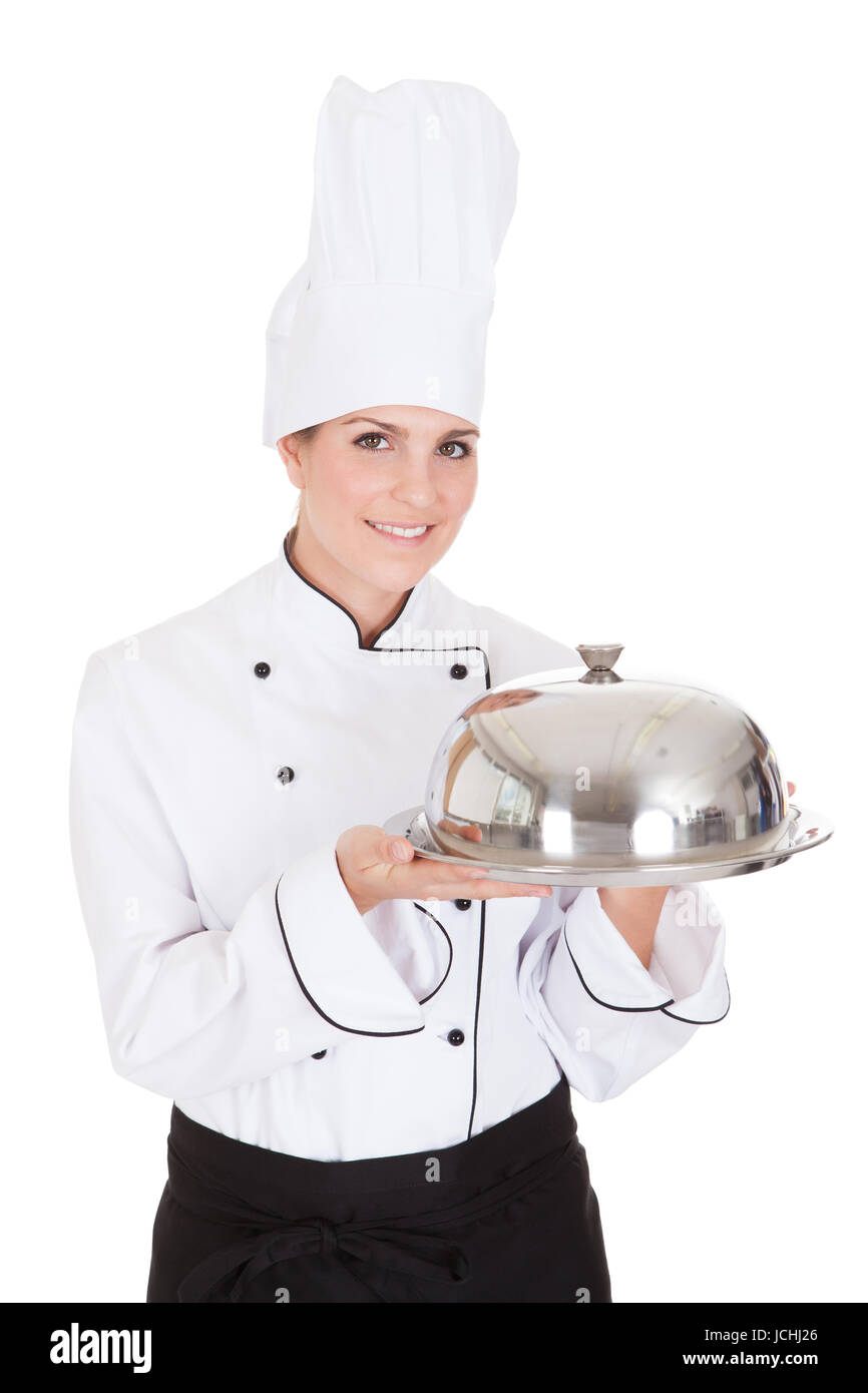 Portrait Of Female Chef Holding Tray Over White Background Stock Photo ...