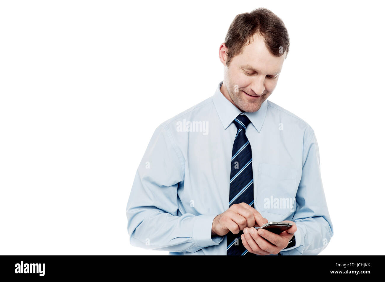 Happy business man texting on his mobile phone Stock Photo - Alamy