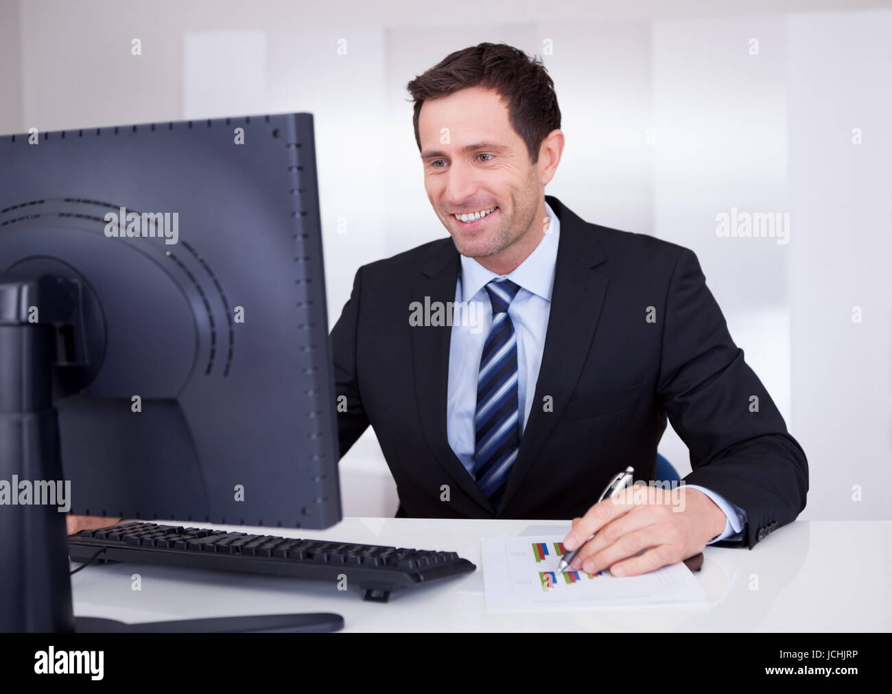 Portrait Of Happy Businessman At Workplace In the Office Stock Photo ...