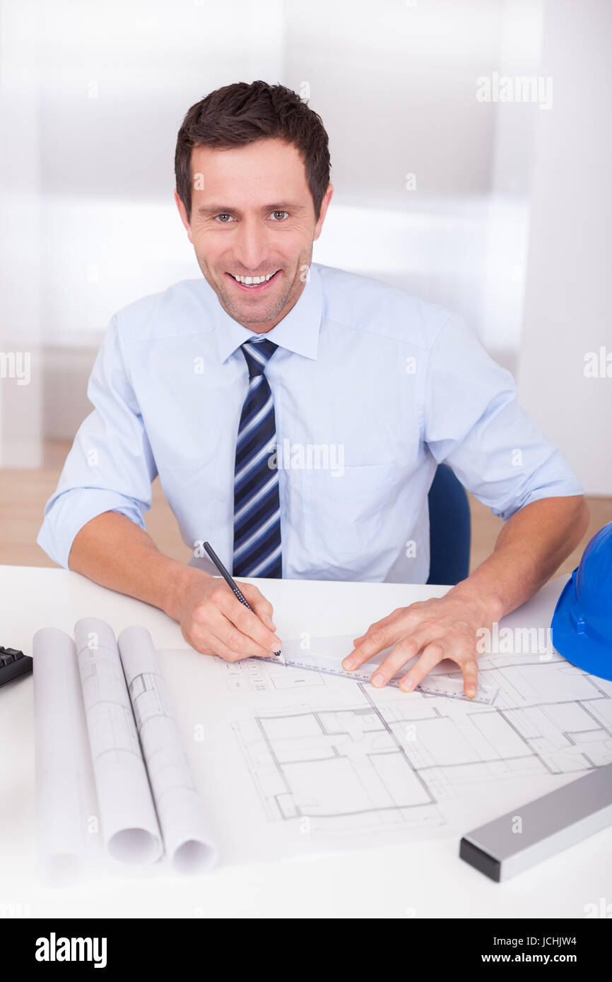 Portrait Of Architect With Blueprint In The Office Stock Photo - Alamy