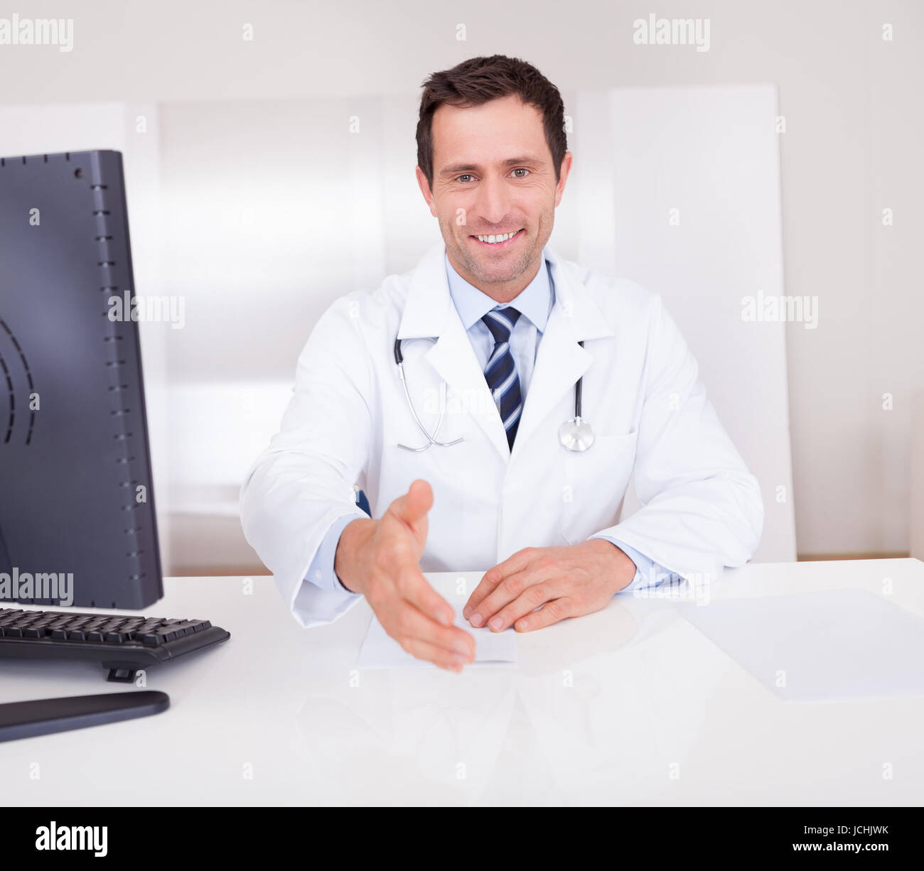 Portrait Of Happy Male Doctor Giving Hand For Handshaking Stock Photo ...