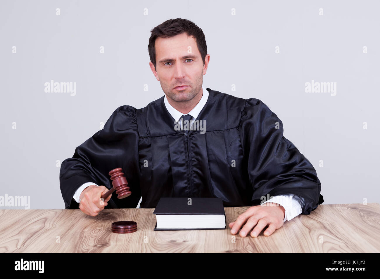 Male Judge In A Courtroom Striking The Gavel Stock Photo - Alamy