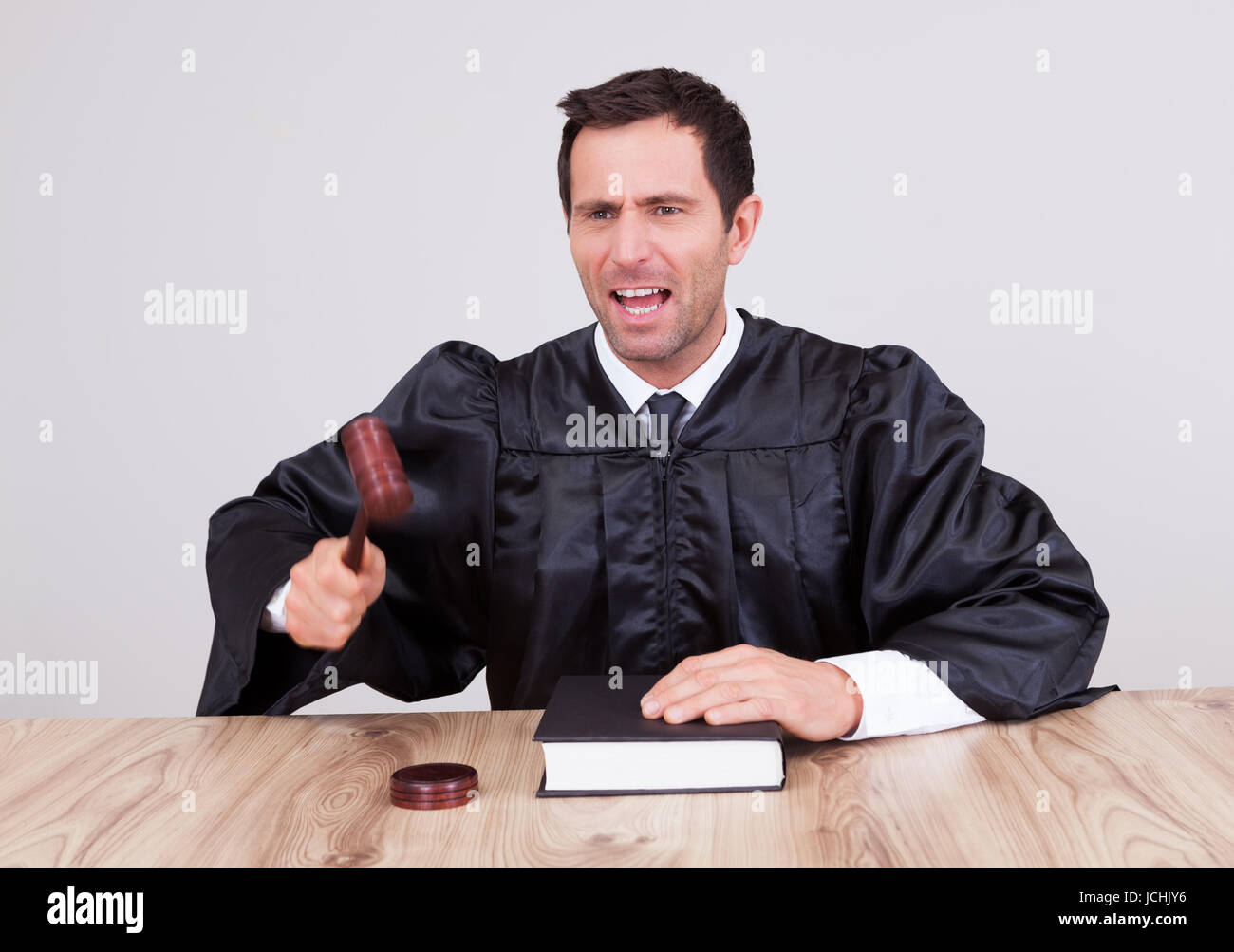 Male Judge In A Courtroom Striking The Gavel Stock Photo - Alamy