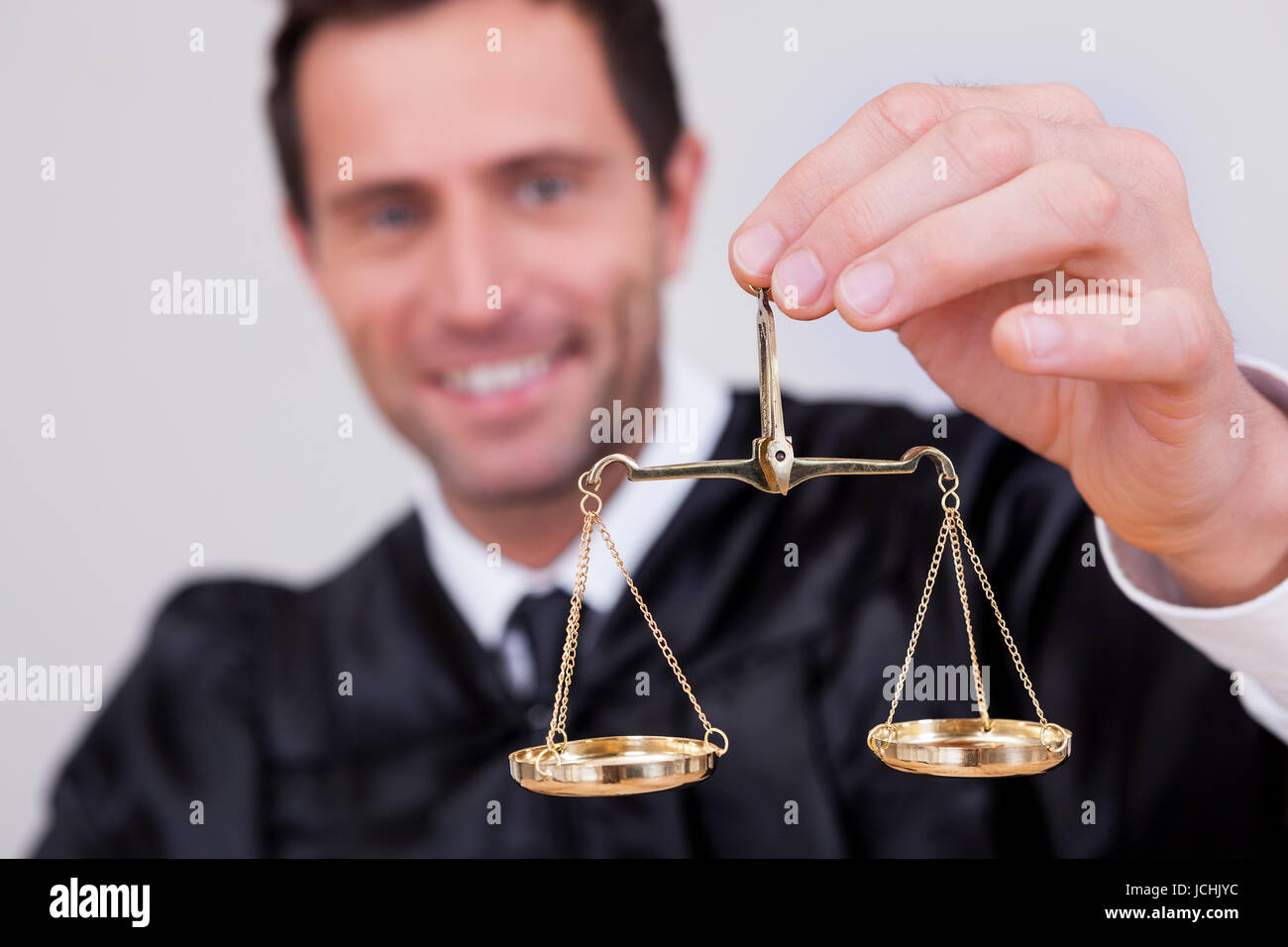 Male Judge Holding The Scale In Courtroom Stock Photo - Alamy