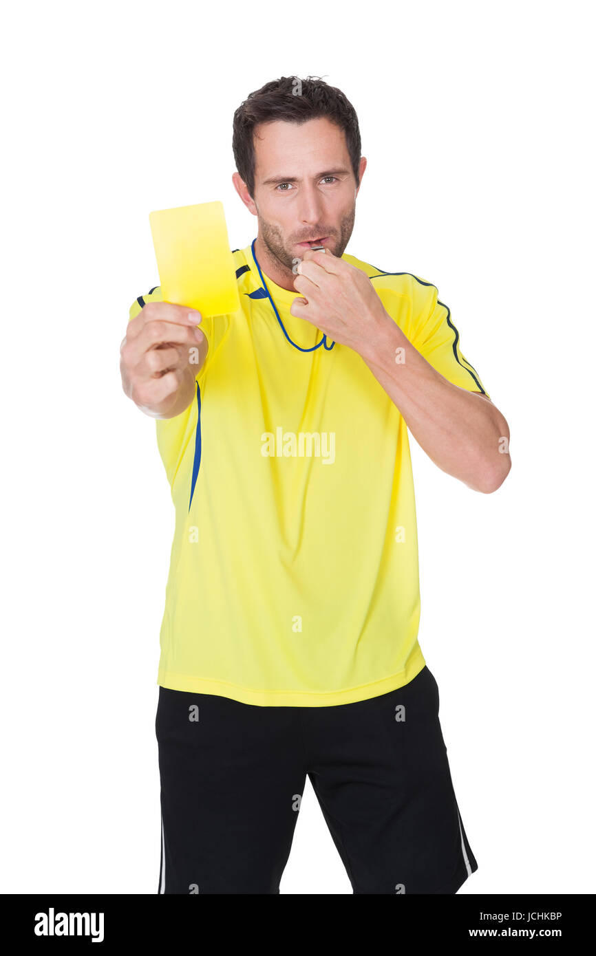Soccer judge whistling and showing yellow card. Isolated on white Stock ...