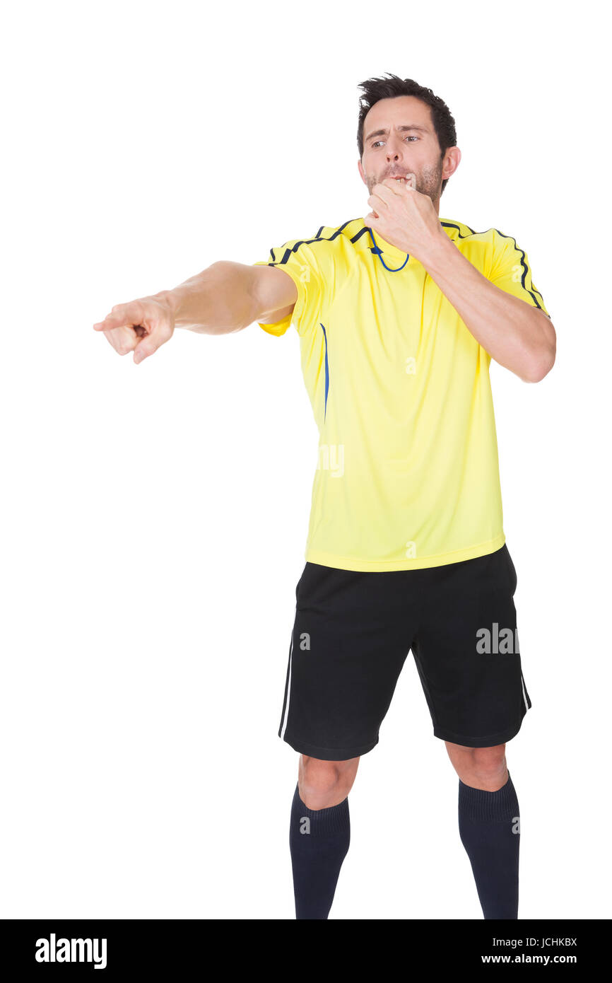 Soccer judge whistling. Isolated on white background Stock Photo - Alamy
