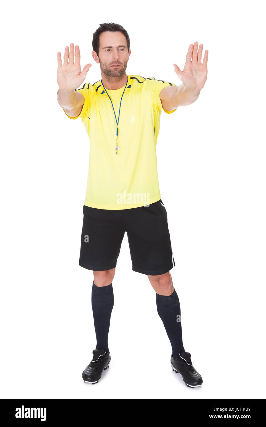 Soccer judge whistling. Isolated on white background Stock Photo - Alamy