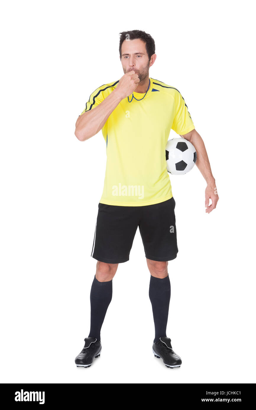 Soccer judge standing with ball. Isolated on white background Stock ...