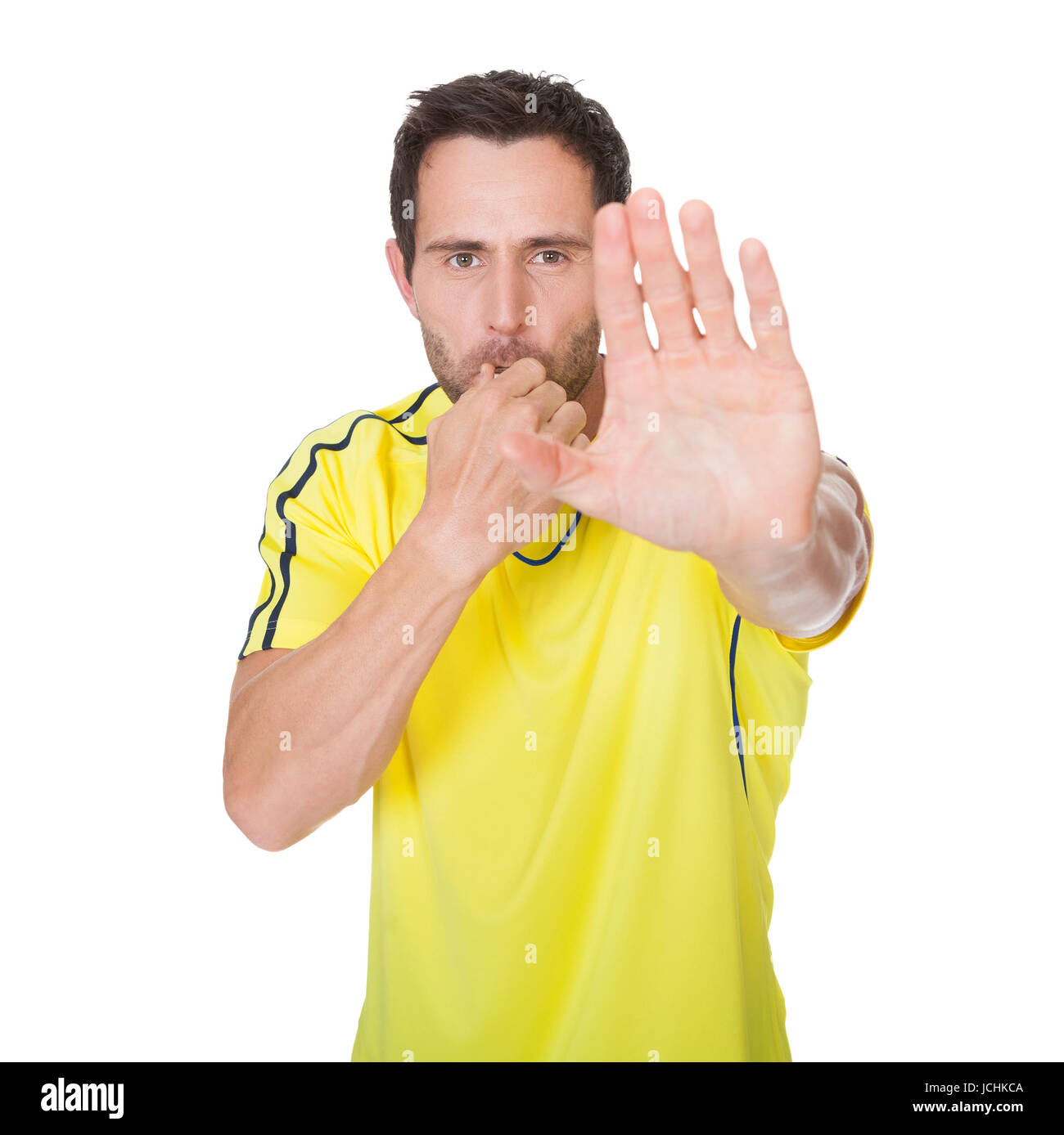 Soccer judge whistling. Isolated on white background Stock Photo - Alamy