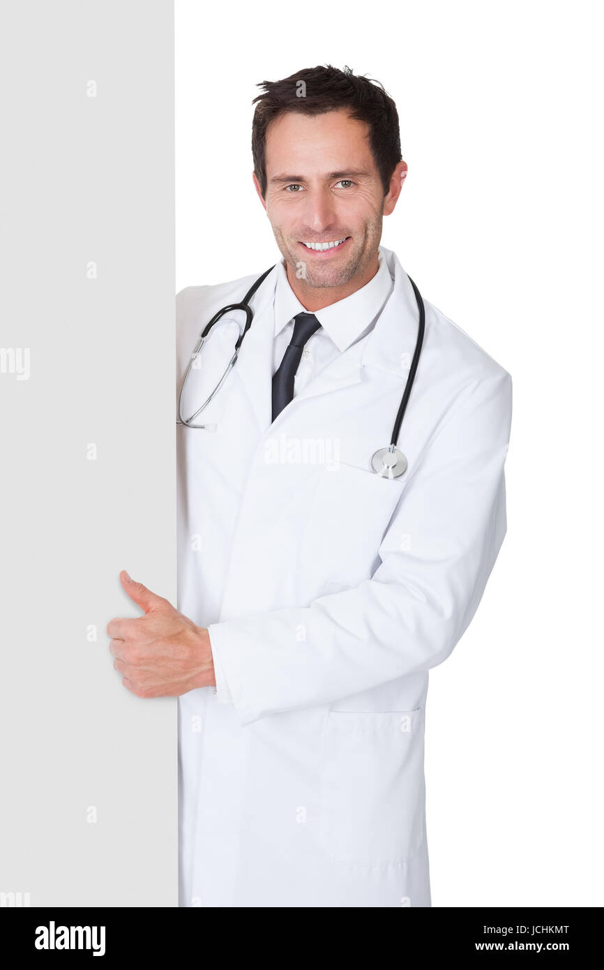 Portrait of friendly doctor presenting empty banner. Isolated on white ...