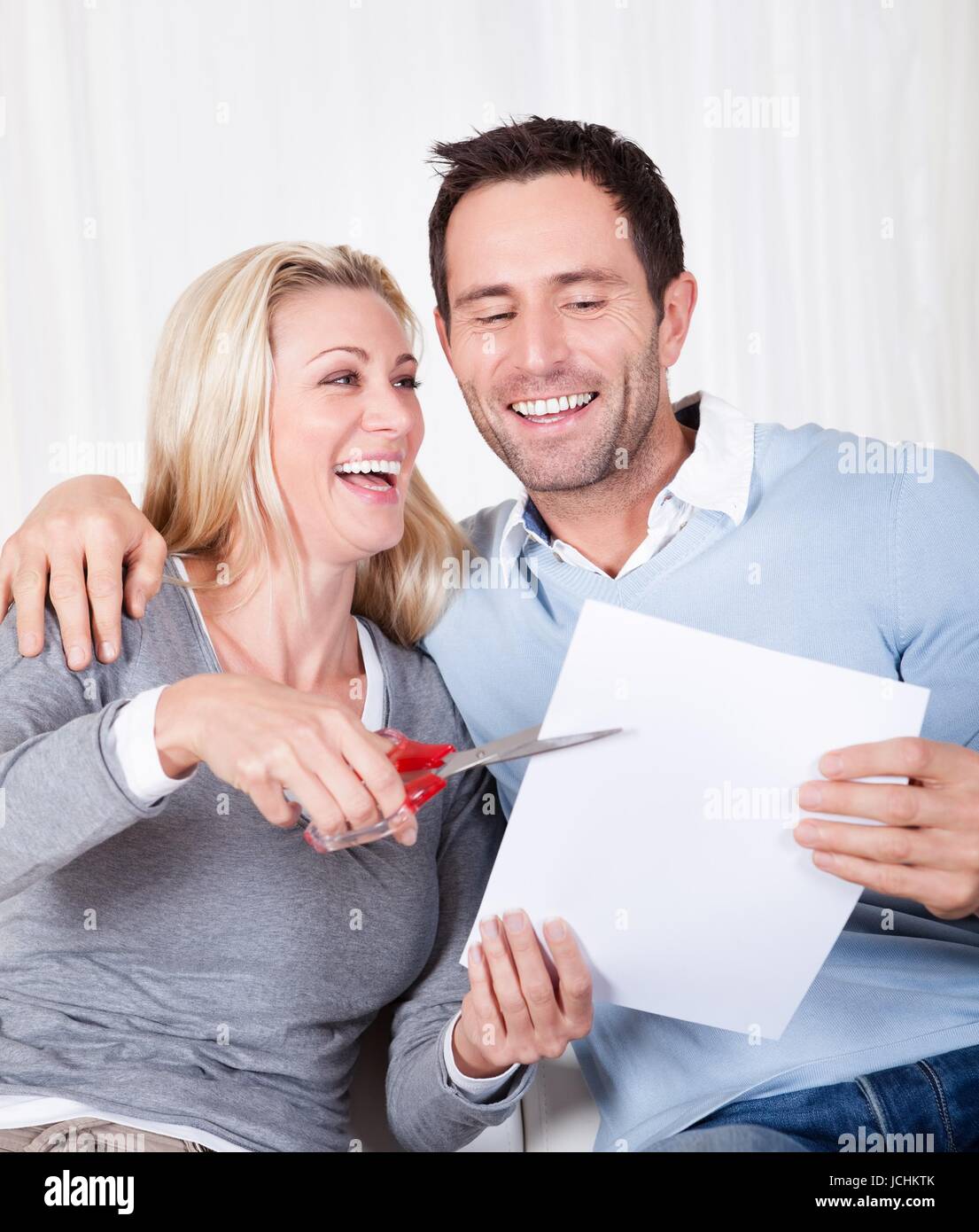 Woman holding scissors laughing hi-res stock photography and images - Alamy