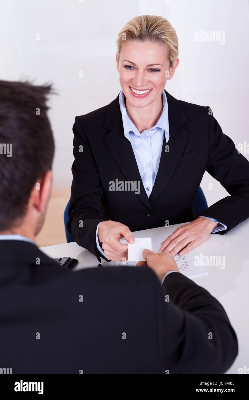 Business colleagues exchanging card hi-res stock photography and images ...