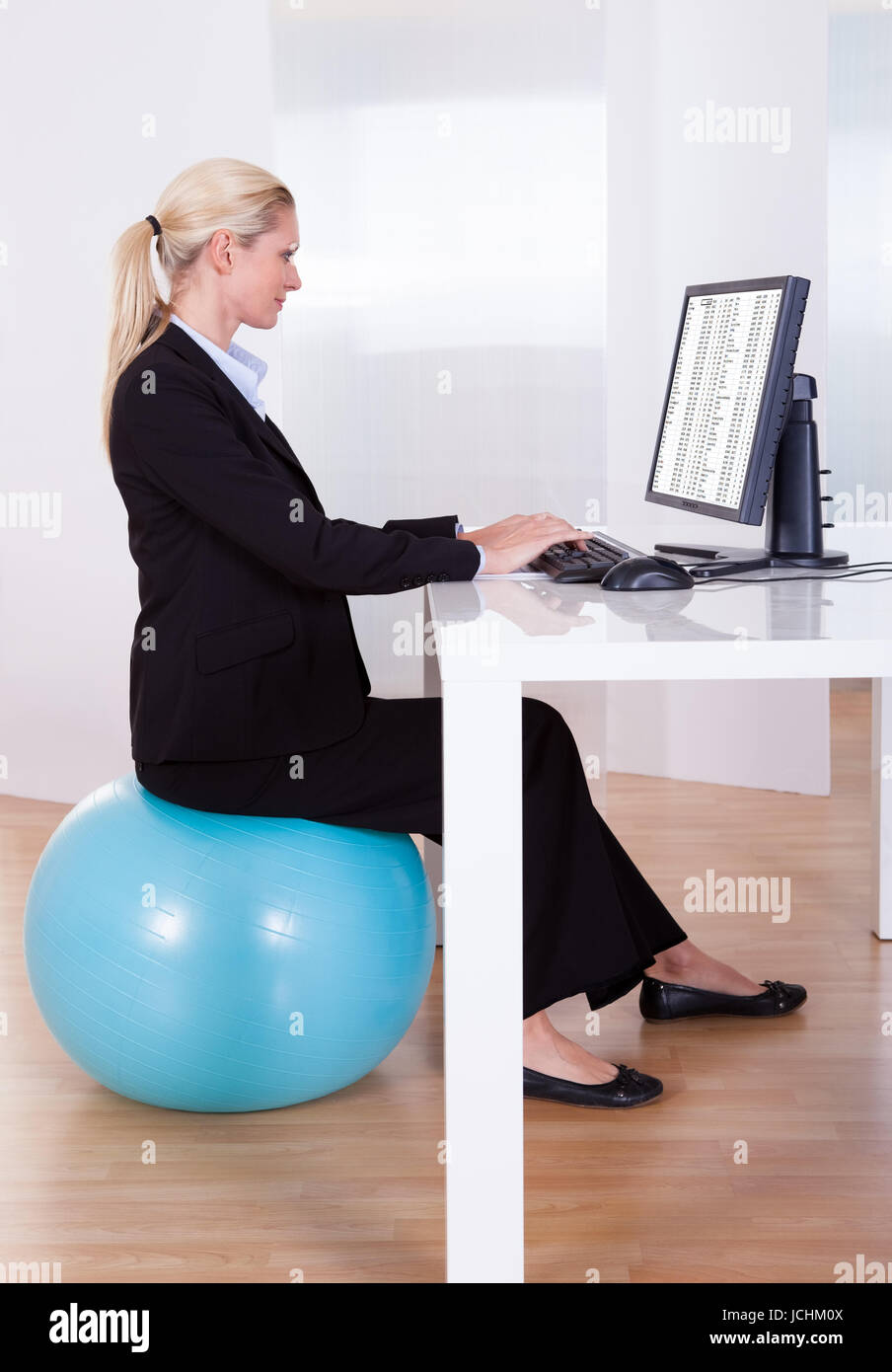 Comfortable working environment with an elegant young blonde office ...