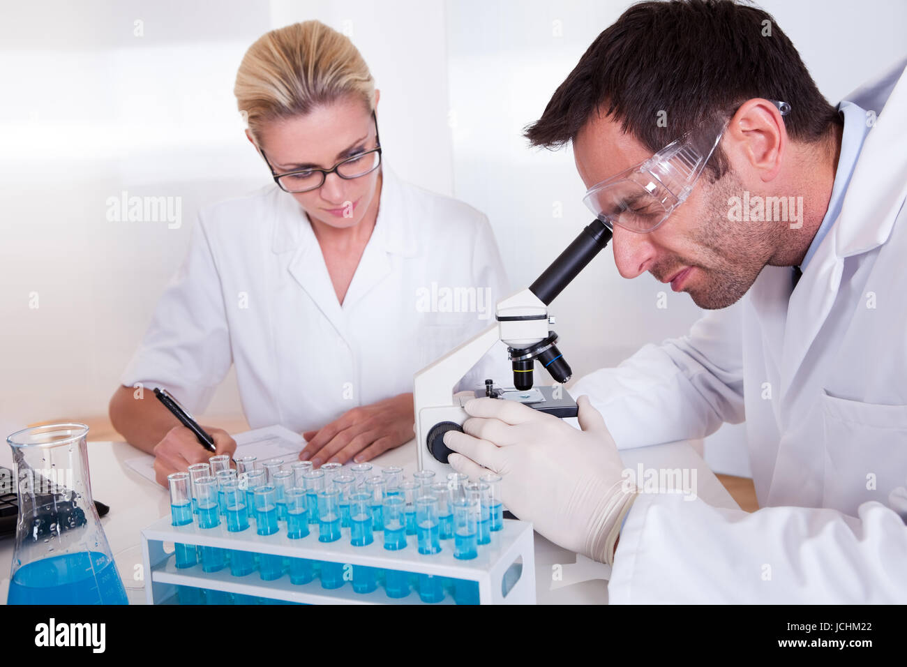Technicians or medical staff in a laboratory working with test tubes in ...