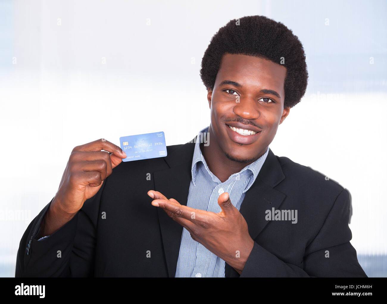 Portrait Of Young Happy Businessman Holding Credit Card Stock Photo - Alamy