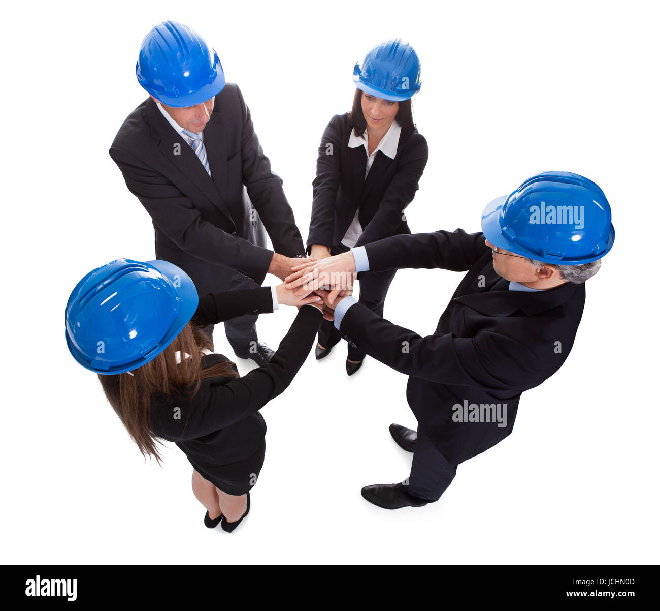 Group Of Architects Stacking Hand Over Each Other On White Background ...