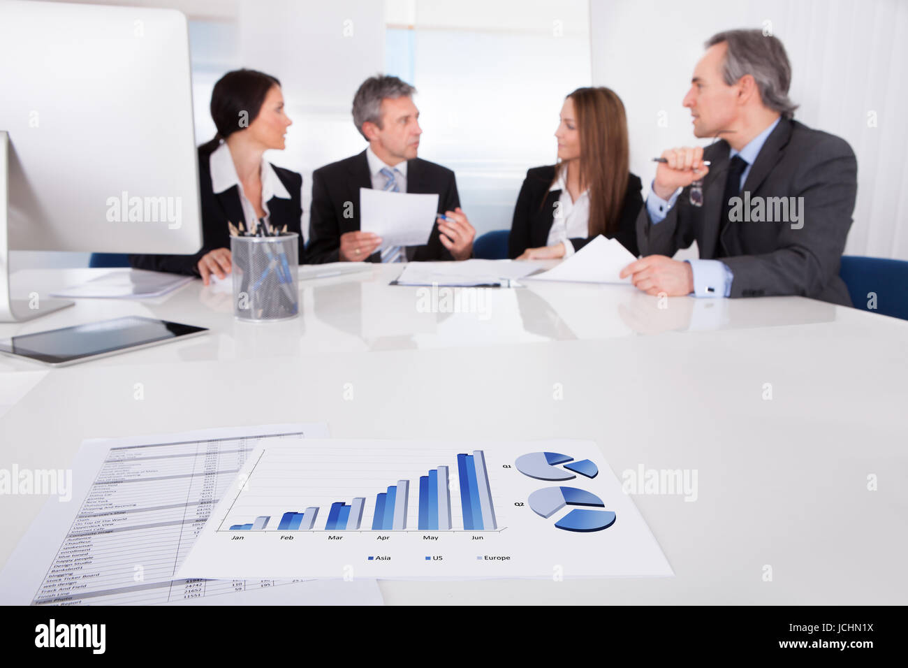 Portrait Of Business People Discussing Plan In Office Stock Photo - Alamy