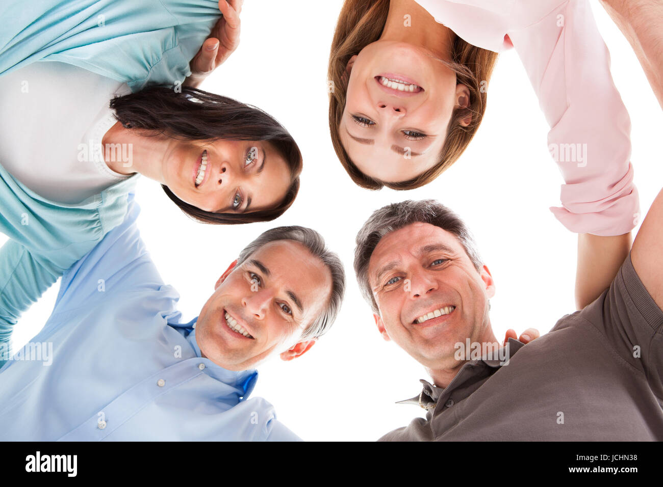Group Of Happy People Making Huddle Over White Background Stock Photo ...
