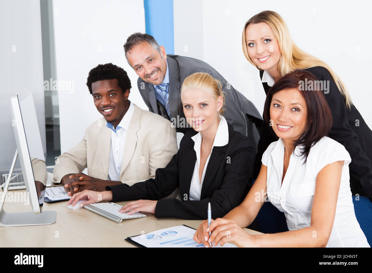 Businessman Showing On Computer To His Colleagues Stock Photo - Alamy