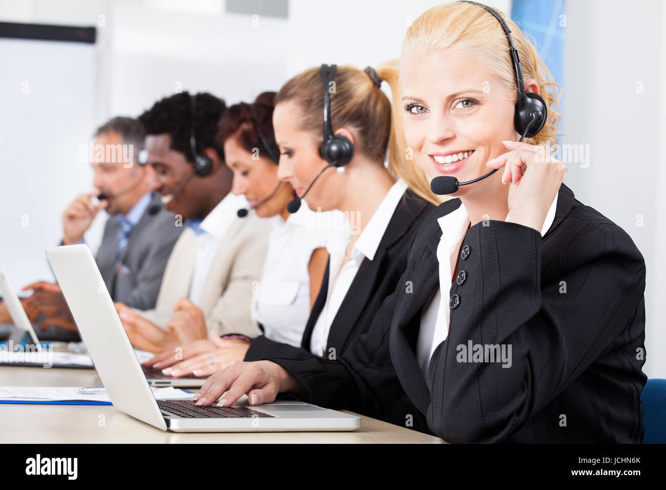 Happy Co-workers Wearing Headsets Working In Call Center Stock Photo ...