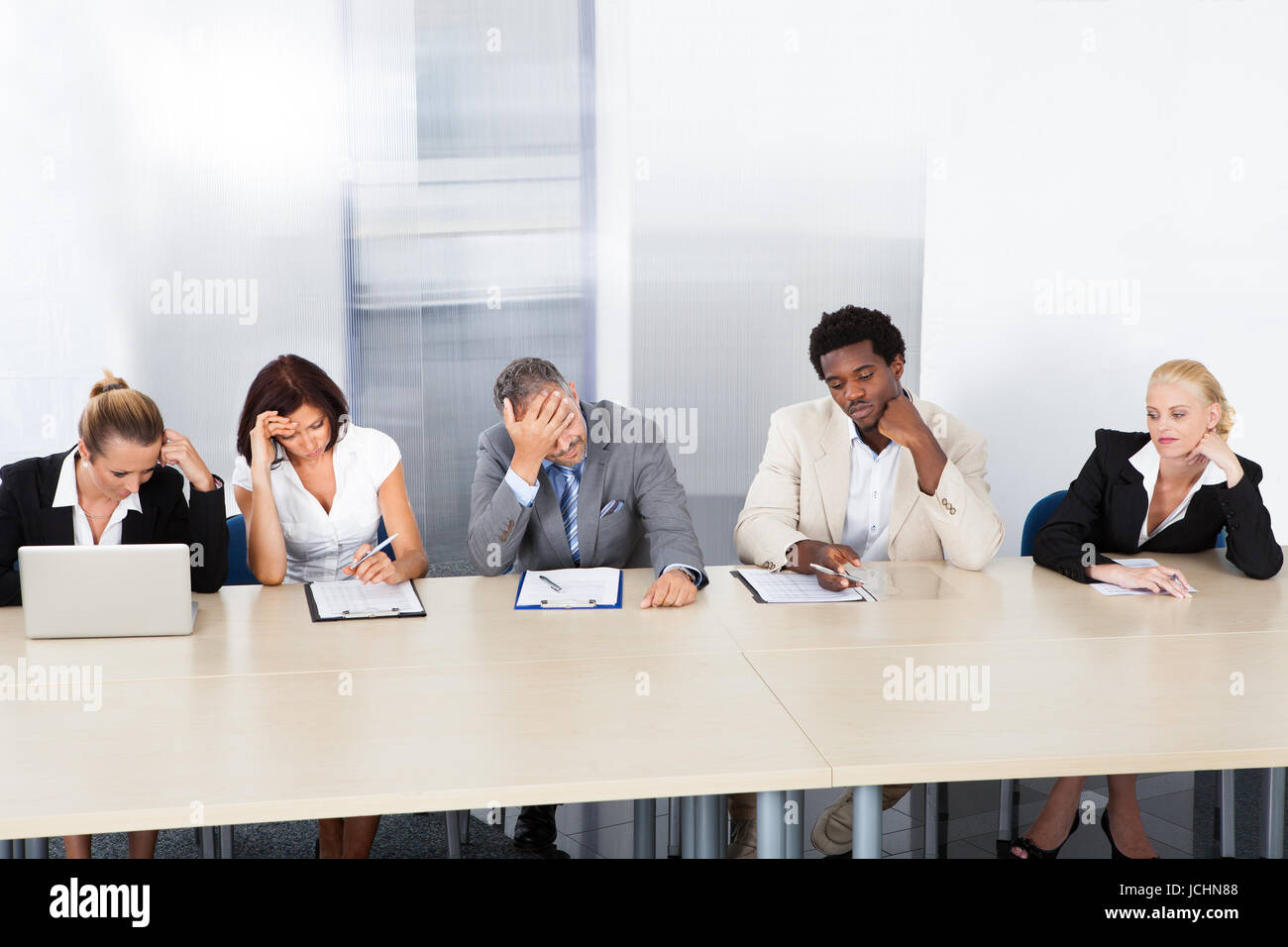 Group Of Tired Corporate Personnel Officers In A Row Stock Photo - Alamy