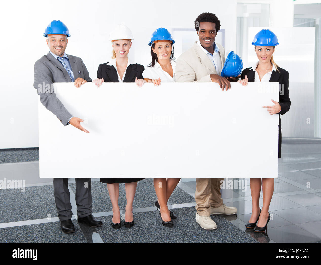 Group Of Happy Multiracial Architects Holding Placard In Office Stock ...