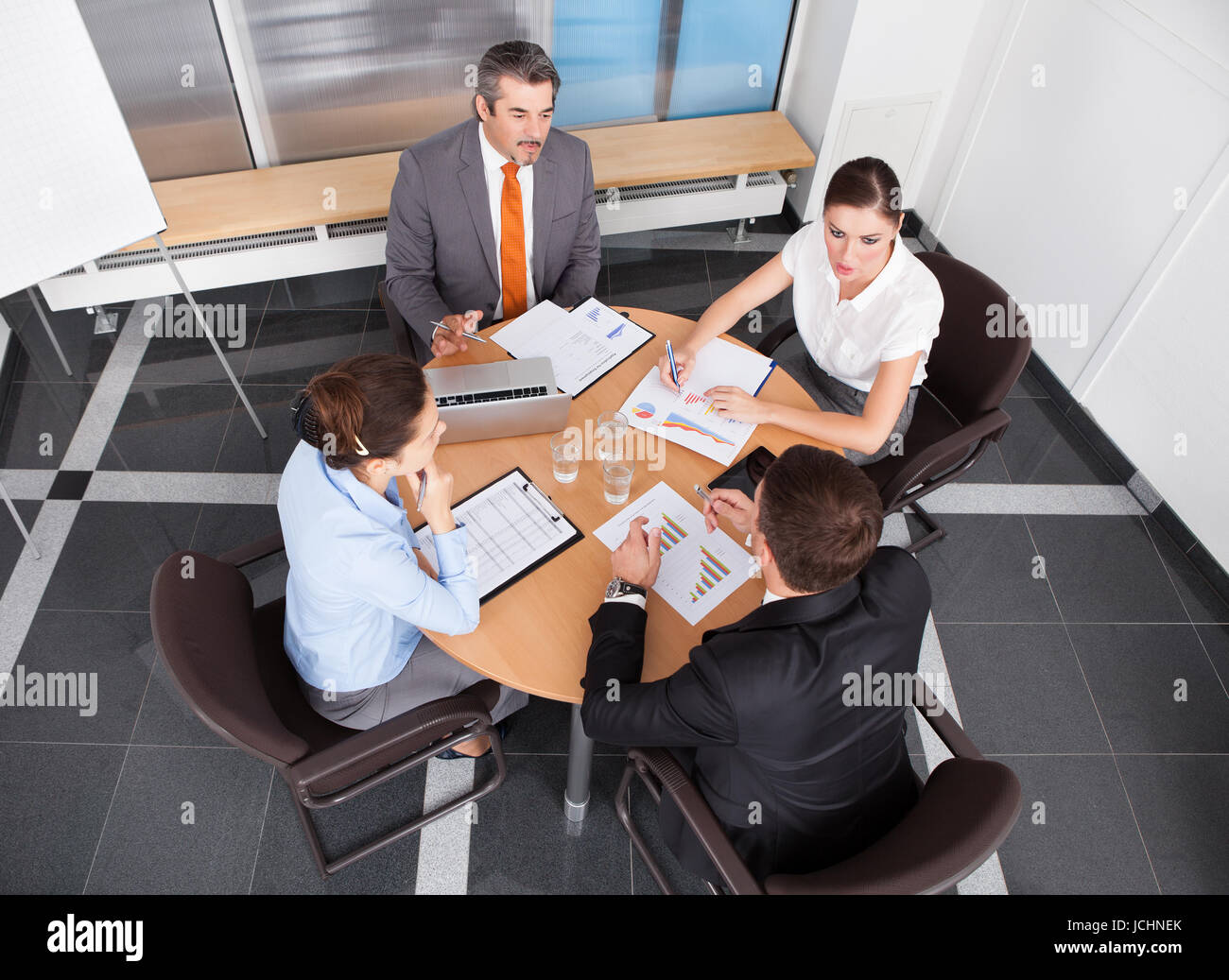 Group Of Coworkers Discussing Together In Office Meeting Stock Photo ...