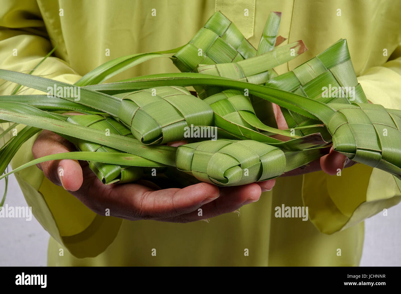 Young muslim adult holding rice dumpling during Eid Mubarak Stock Photo ...