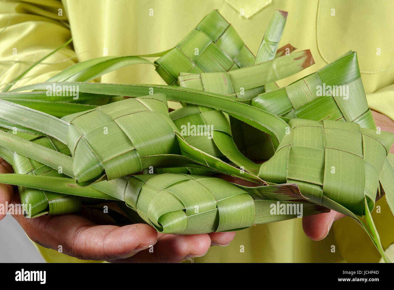 Young muslim adult holding rice dumpling during Eid Mubarak Stock Photo ...