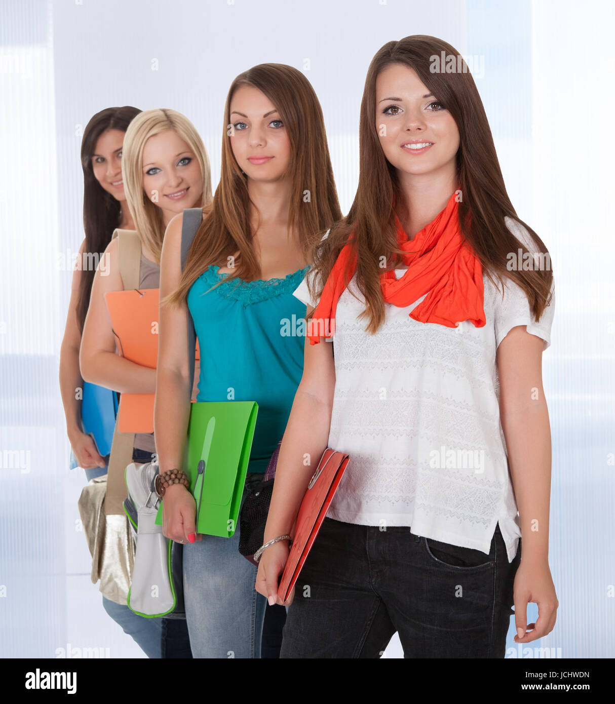 Group Of Happy Young Women Friends Standing In A Row Stock Photo - Alamy