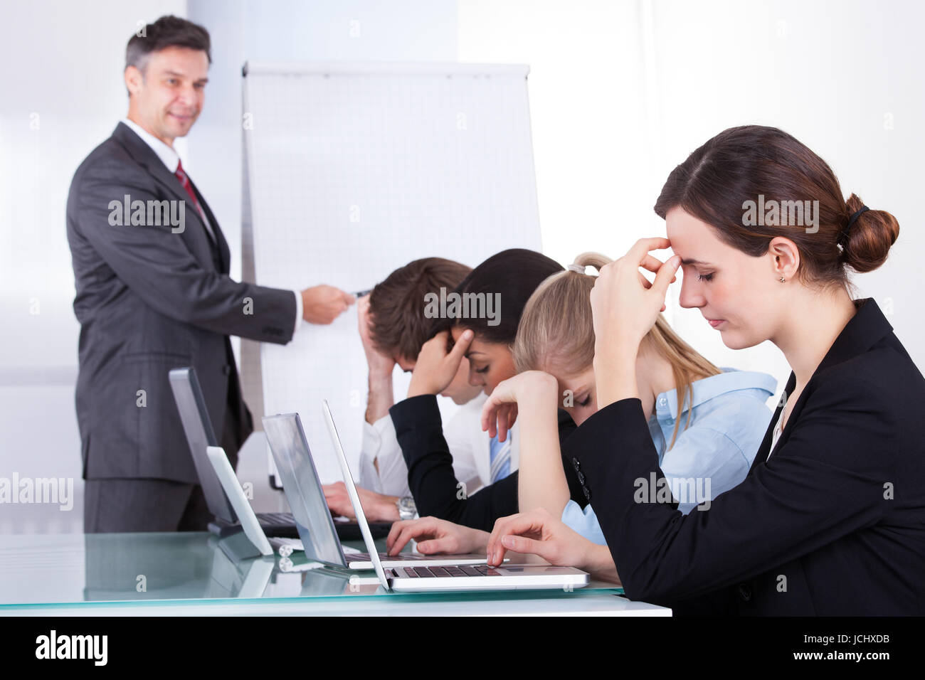 Bored Businesspeople At Presentation With Colleagues In Office Stock ...