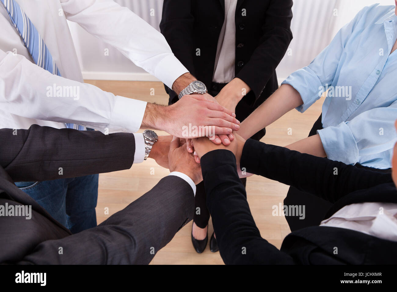 Putting hands work high hi-res stock photography and images - Alamy
