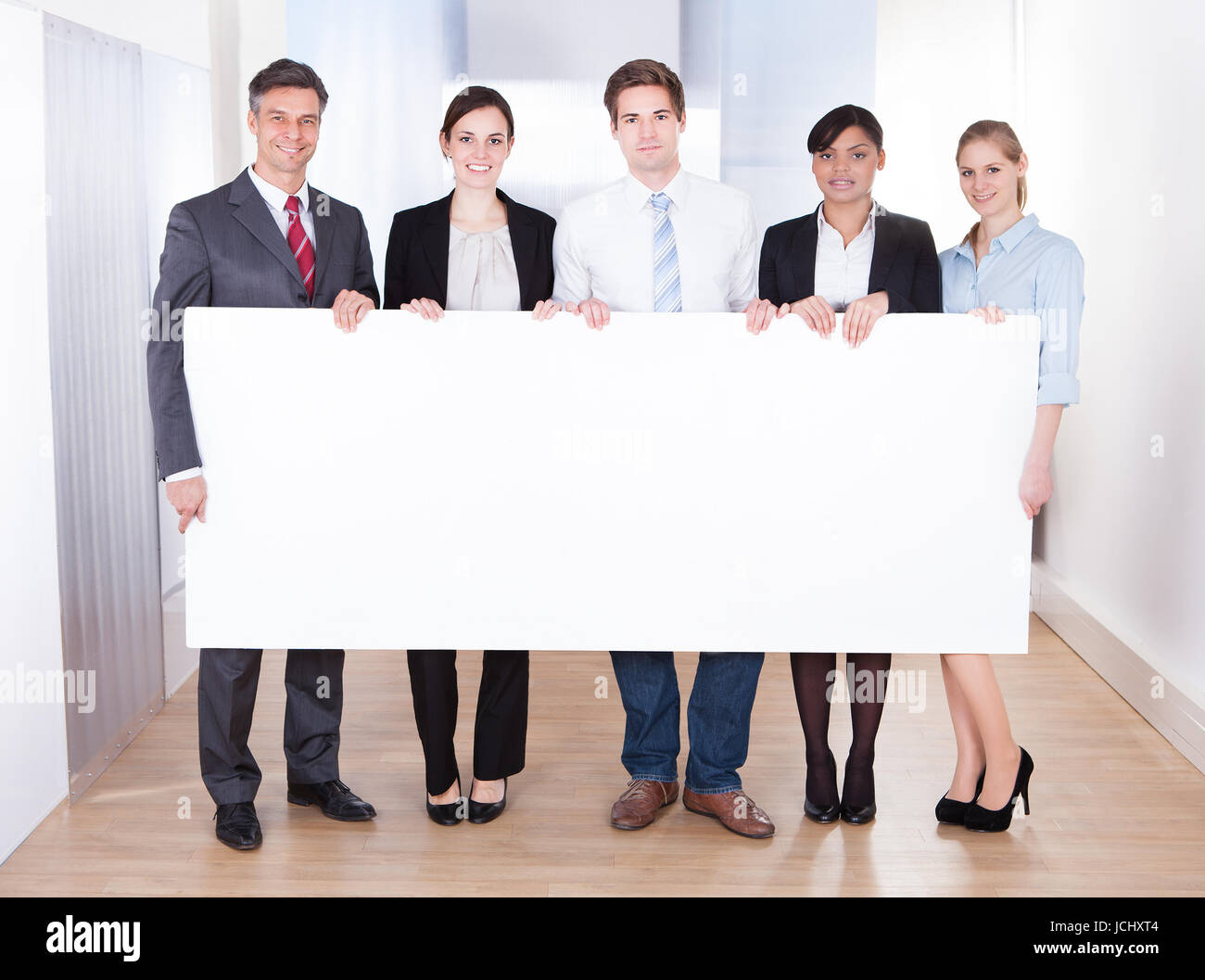 Group Of Happy Businesspeople Holding Blank Placard Stock Photo - Alamy