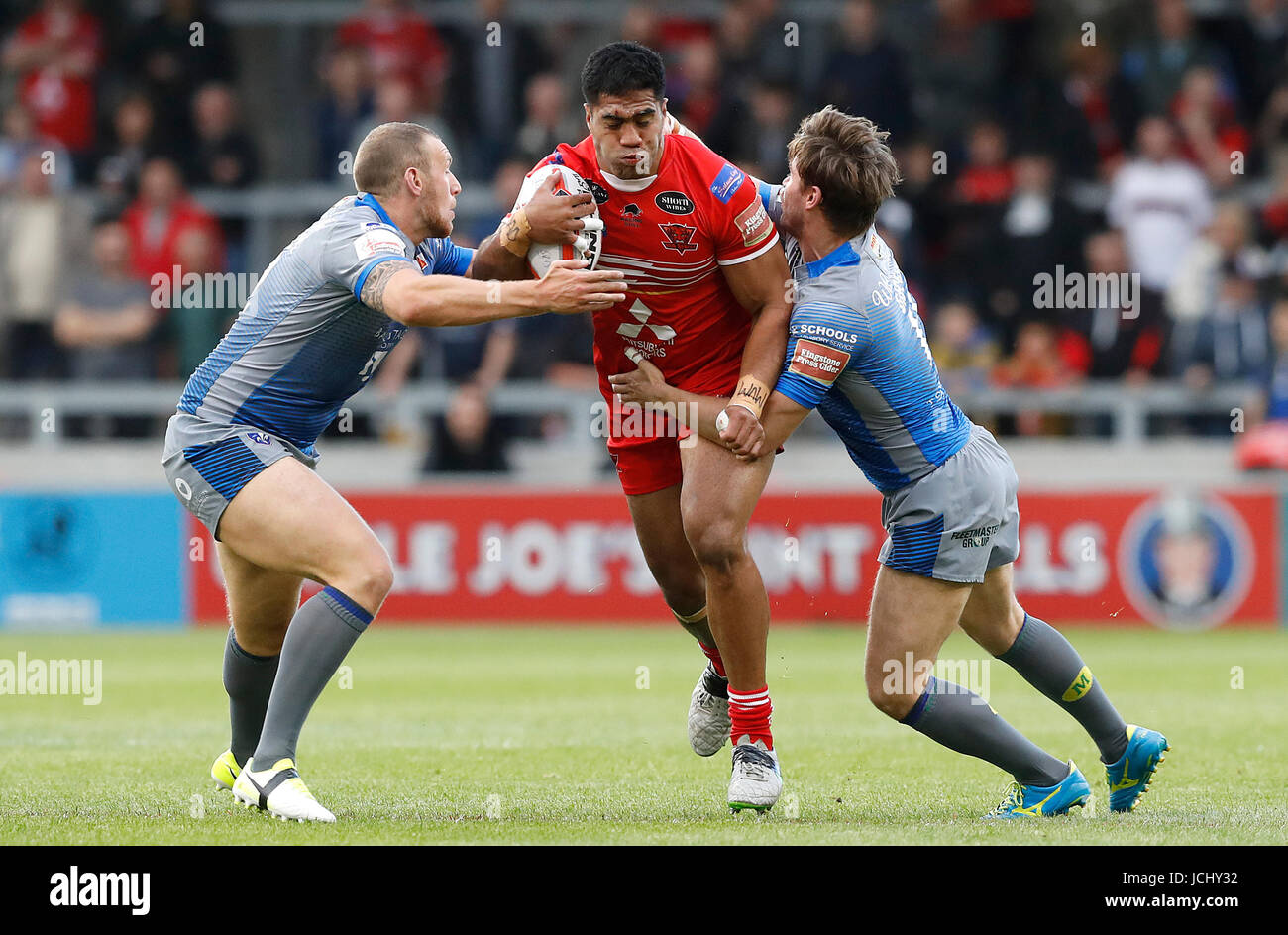 Salford Red Devils' Lama Tasi is tackled by Wakefield Trinity's Dean ...