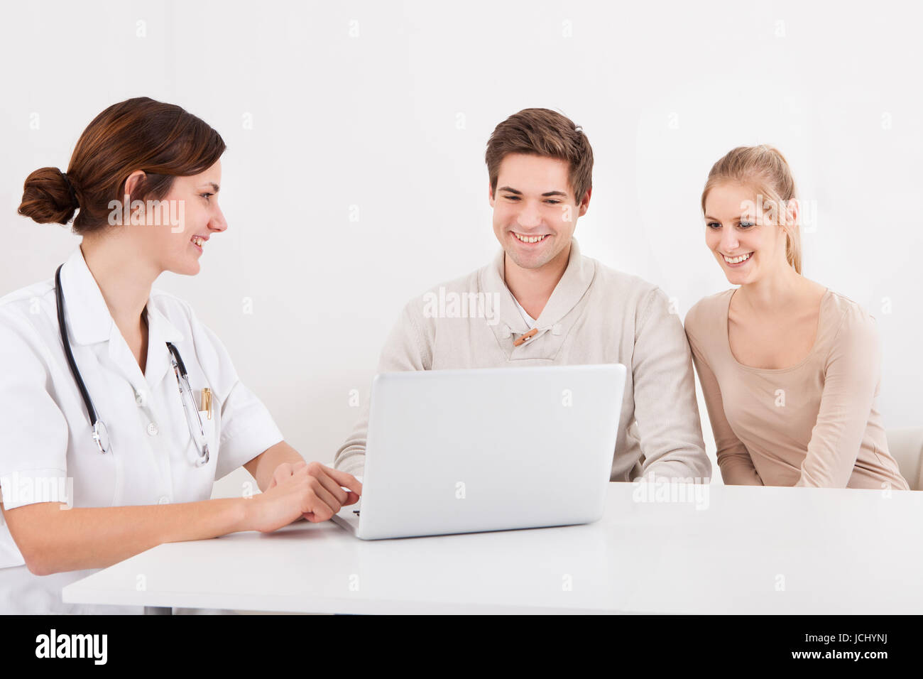 Medical Doctor Showing Results To Patients On Laptop Stock Photo - Alamy