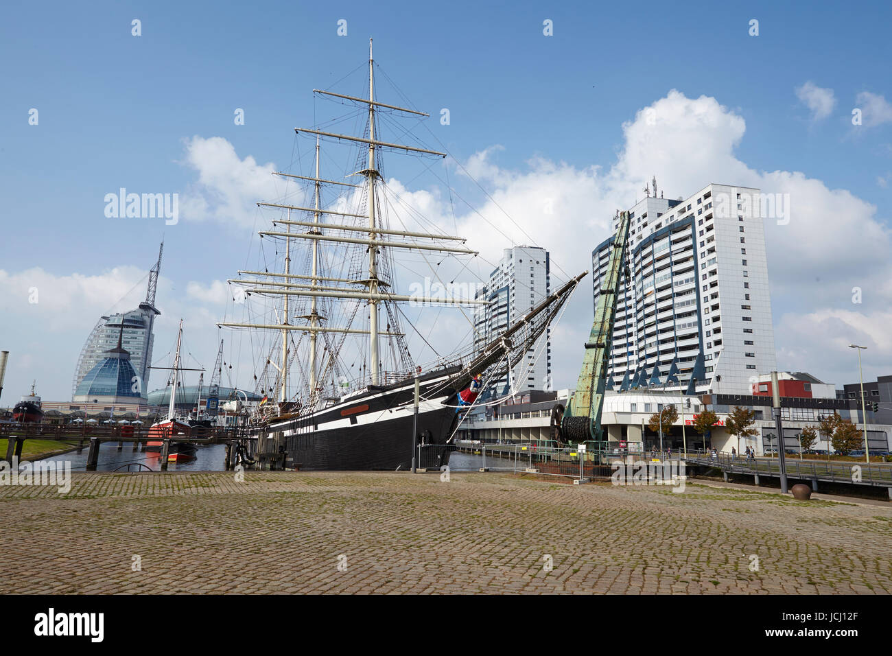 The harbour basin with historical ships and residental towers at the ...
