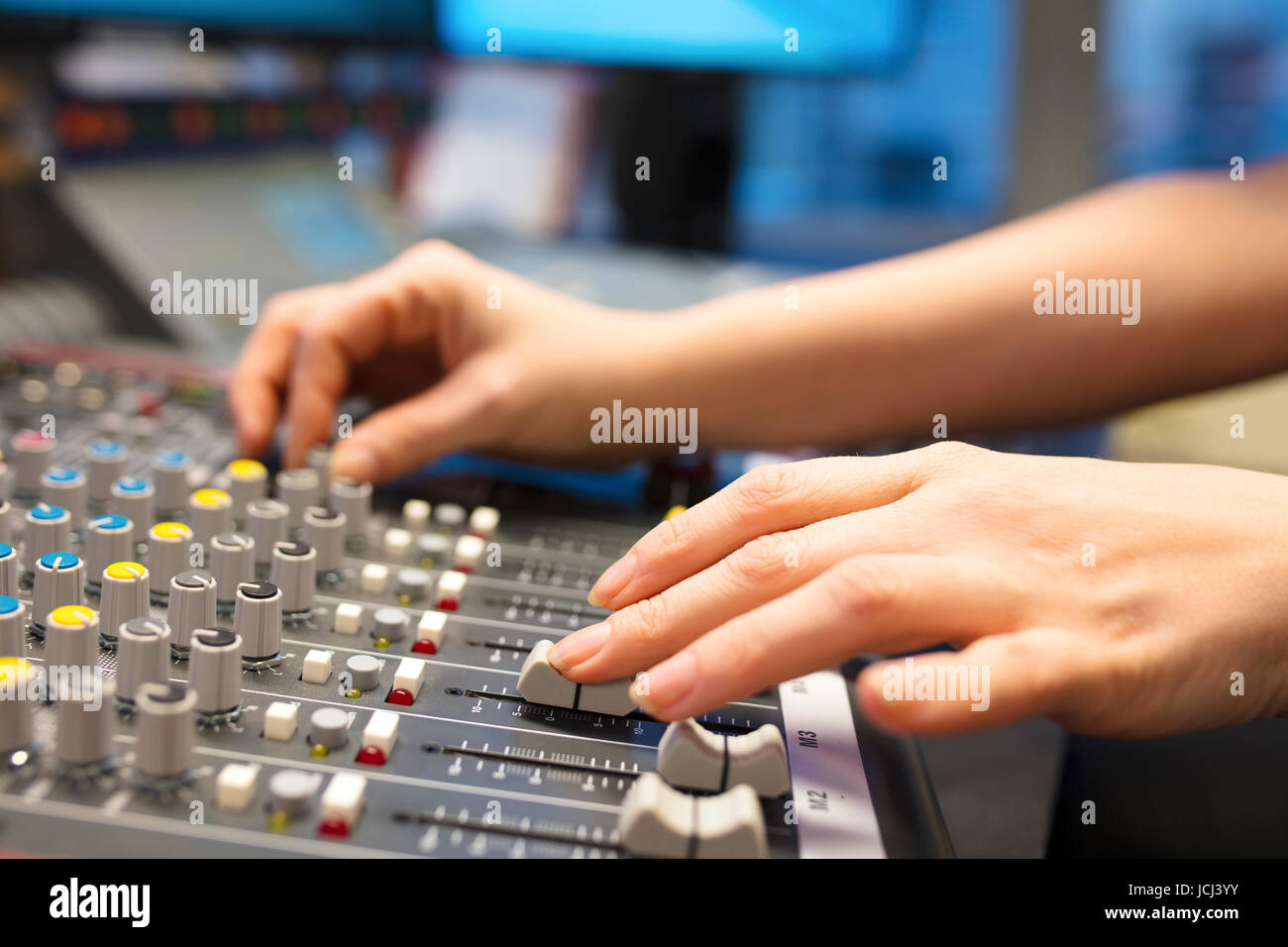 Female Radio Host Using Music Mixer In Studio Stock Photo - Alamy