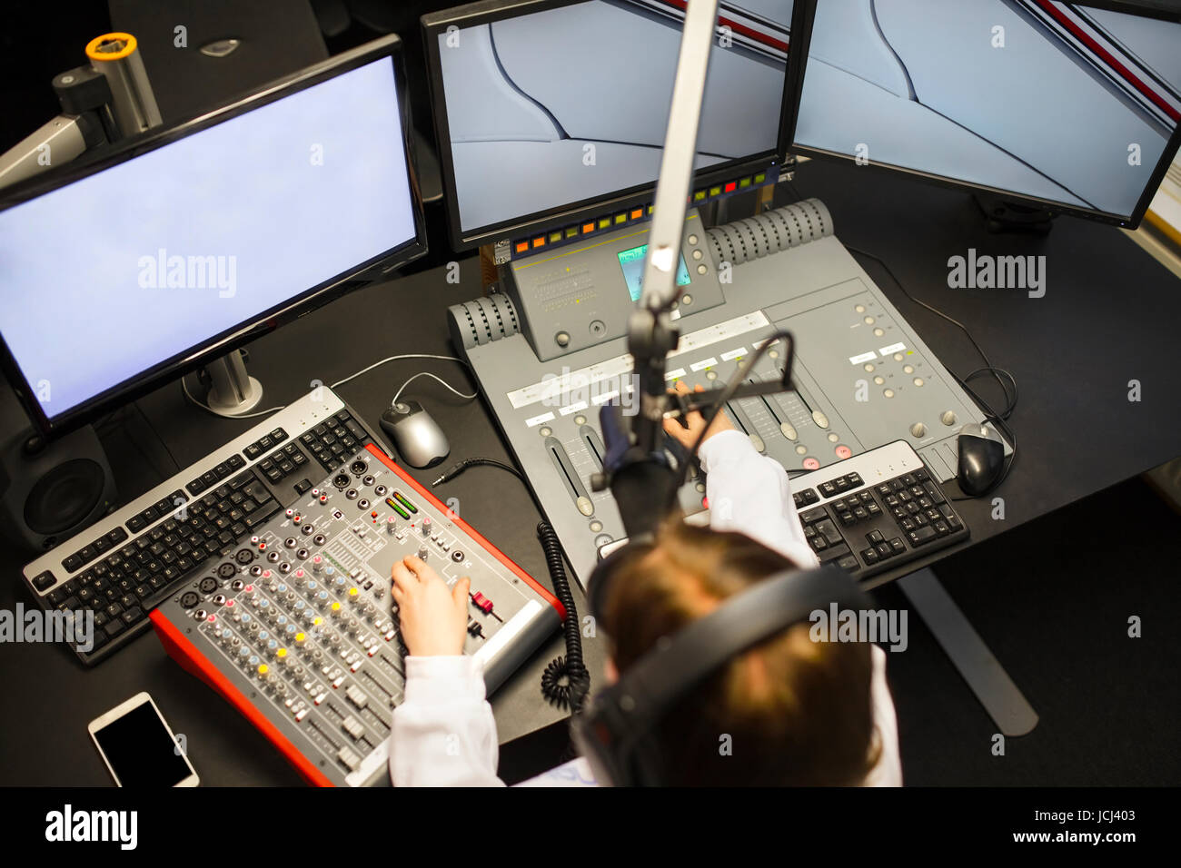 Female Jockey Using Music Mixers And Screens In Radio Studio Stock ...